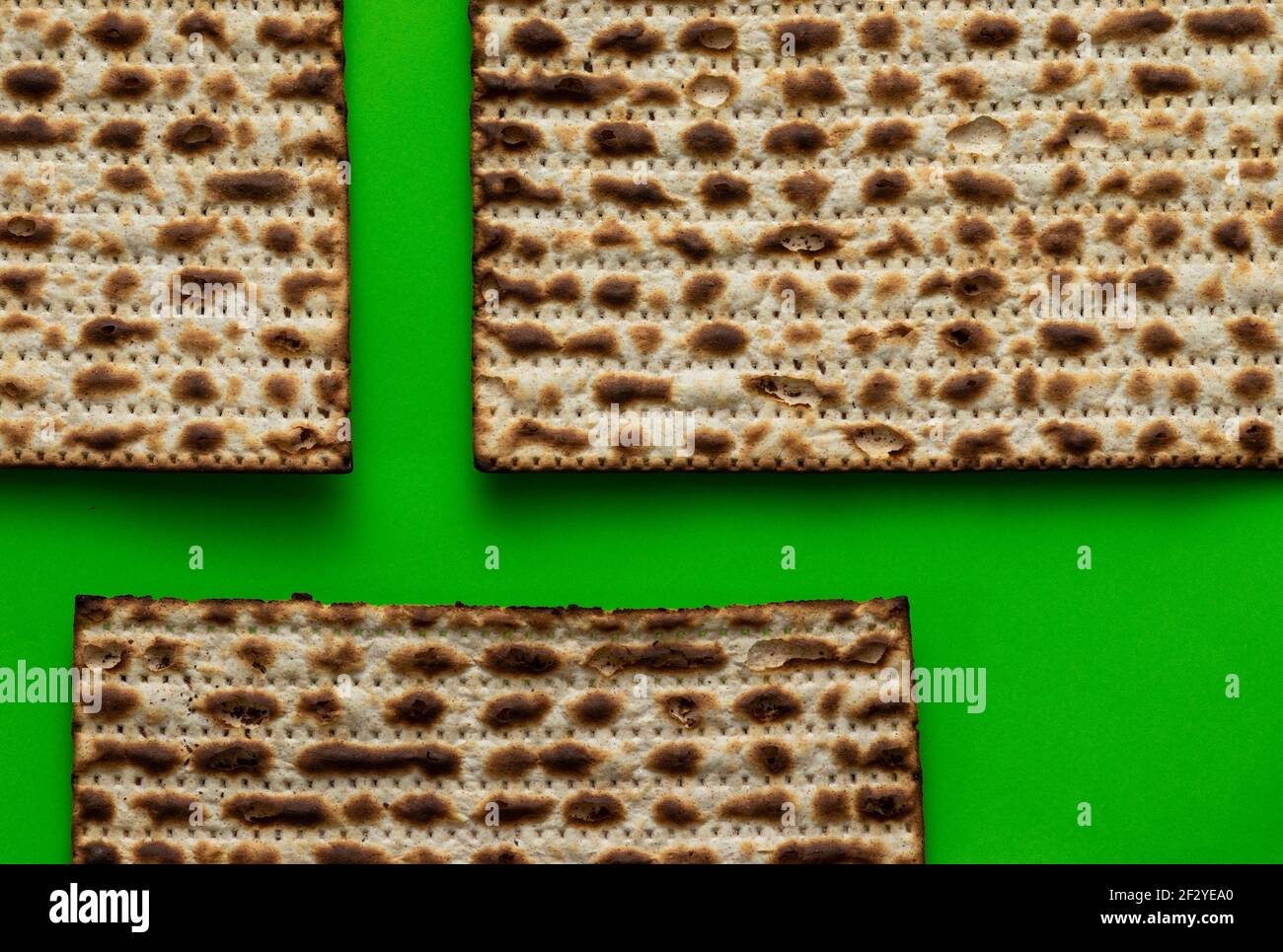 A close-up of three matzahs - bread for the Jewish Passover, on a green ...