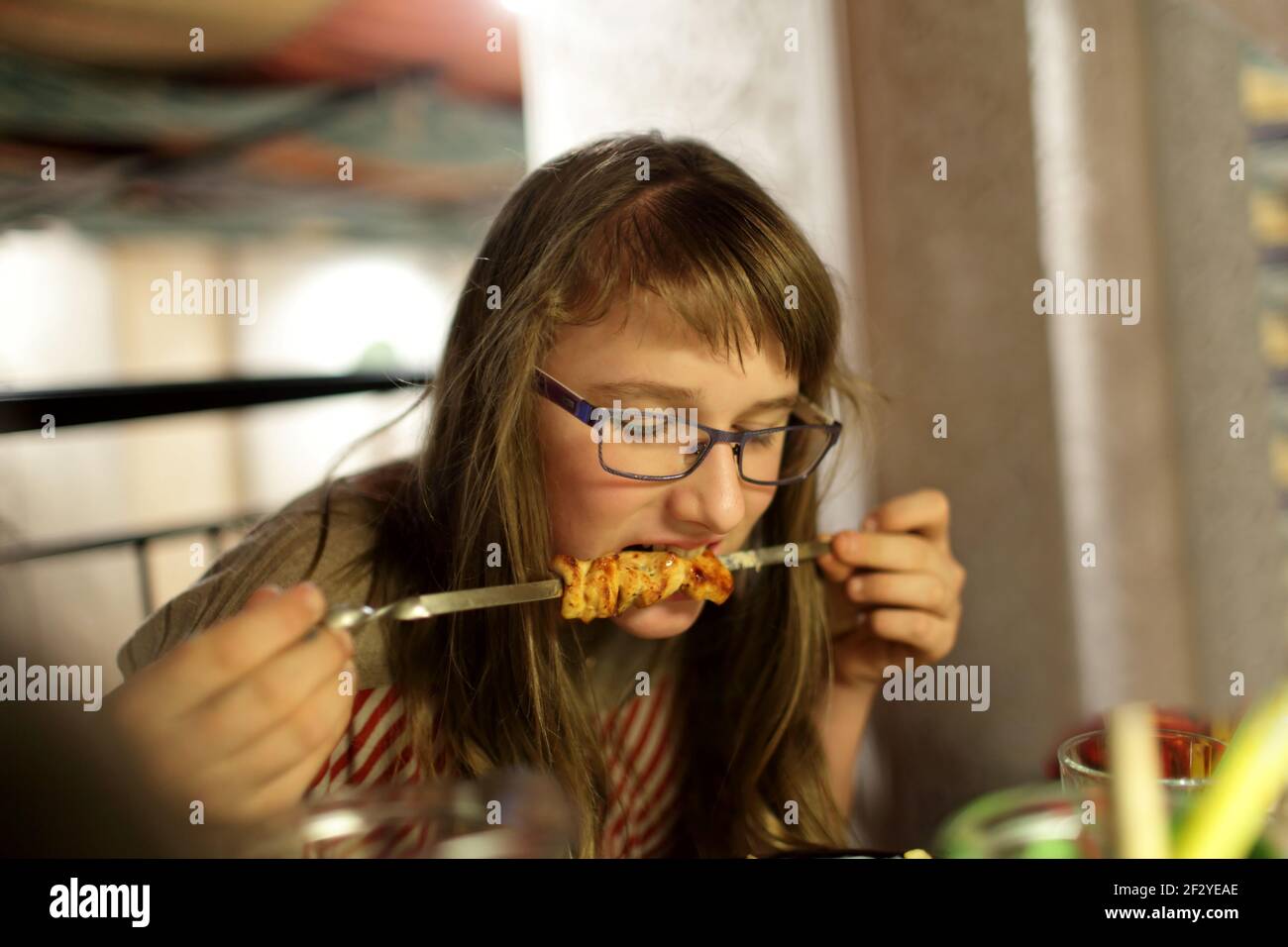 Girl eating kebab in the asian restaurant Stock Photo - Alamy