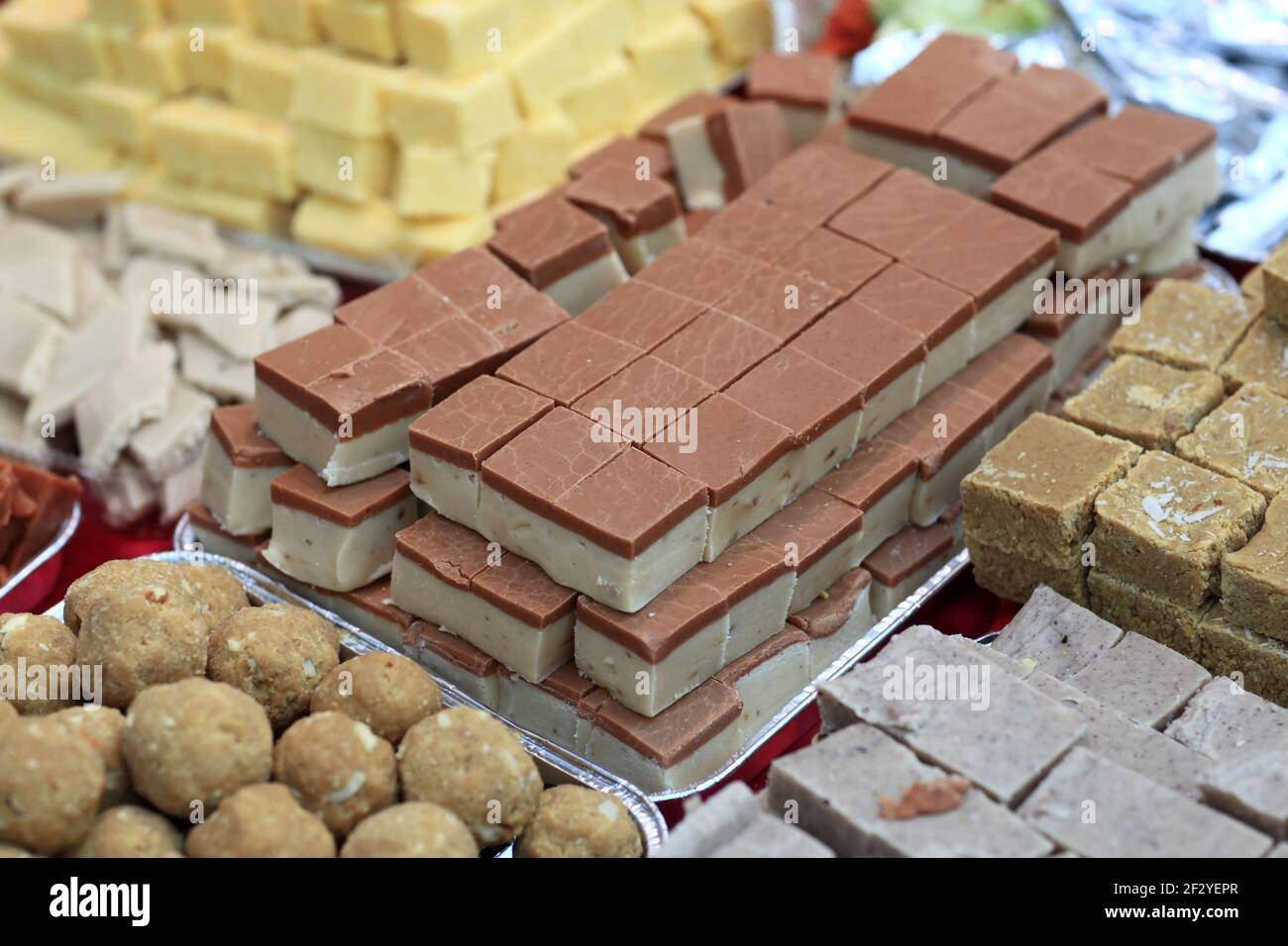 Various indian sweets on the counter an market Stock Photo - Alamy