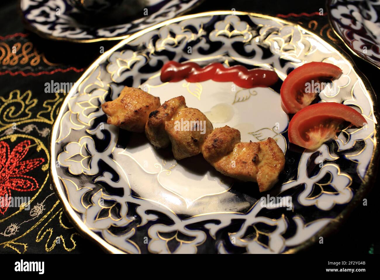 Plate with chiken kebab in the uzbek restaurant Stock Photo - Alamy