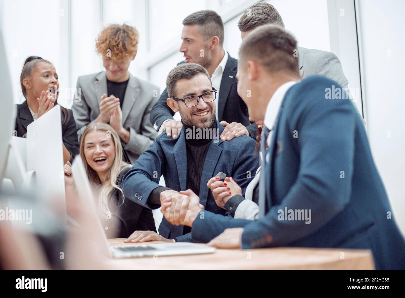 happy business colleagues shaking hands with each other Stock Photo - Alamy