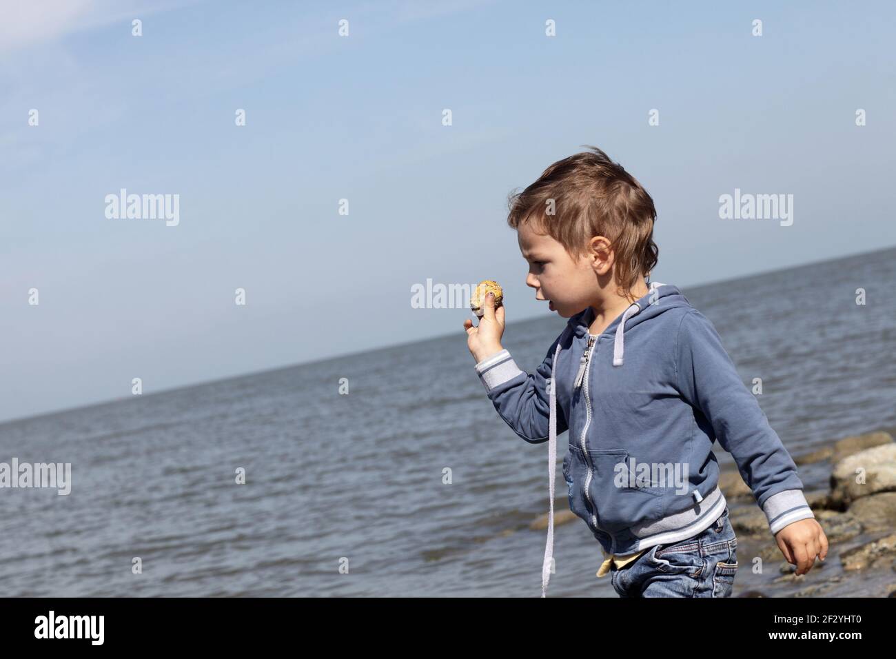 Boy Throwing Pebbles Into The Sea High Resolution Stock Photography and ...