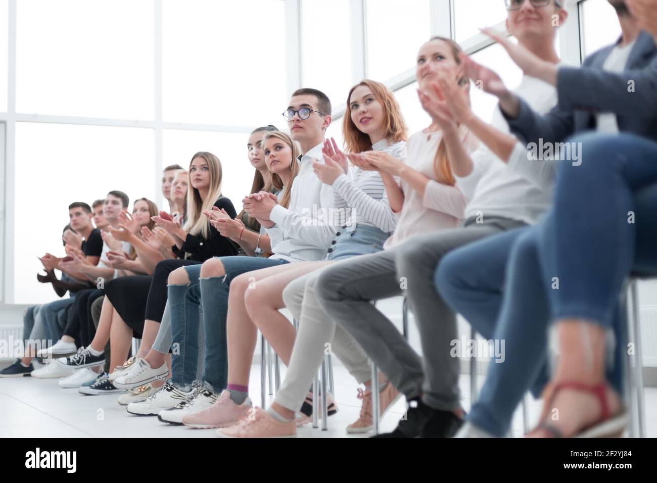 group of diverse young people sitting in a row Stock Photo - Alamy