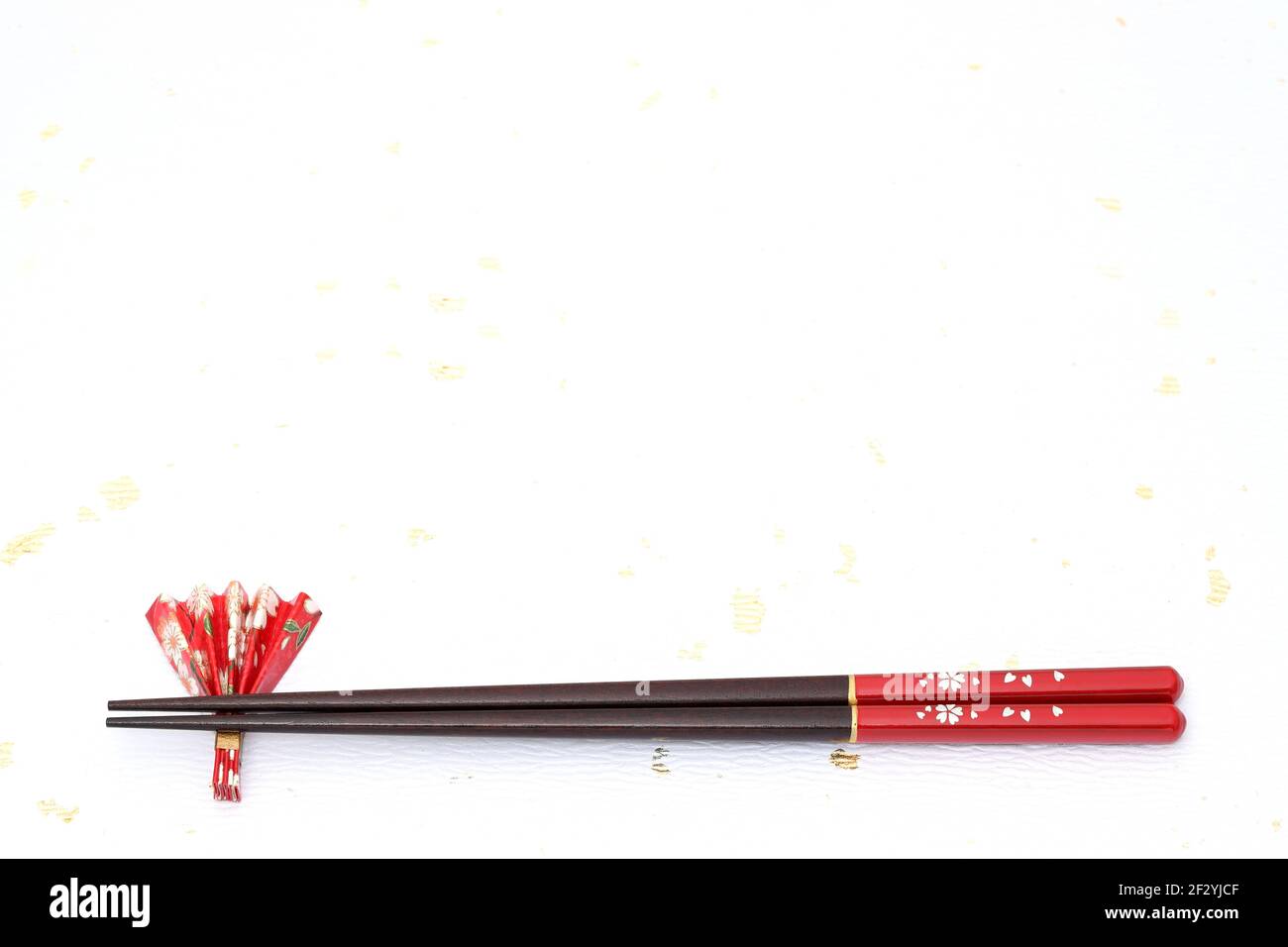Chopsticks and chopsticks-rest on a red table background Stock Photo ...