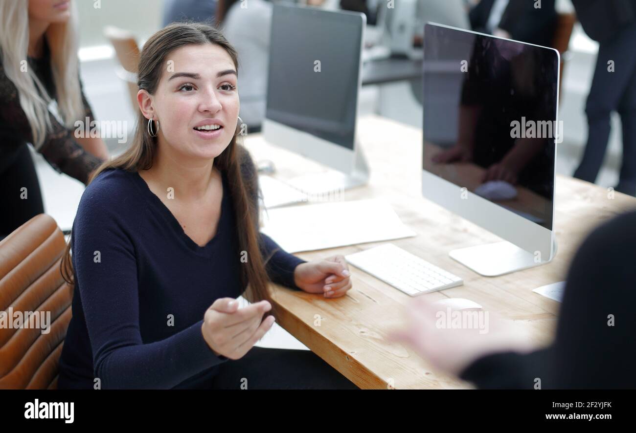 serious young woman asking a question to her colleague Stock Photo - Alamy