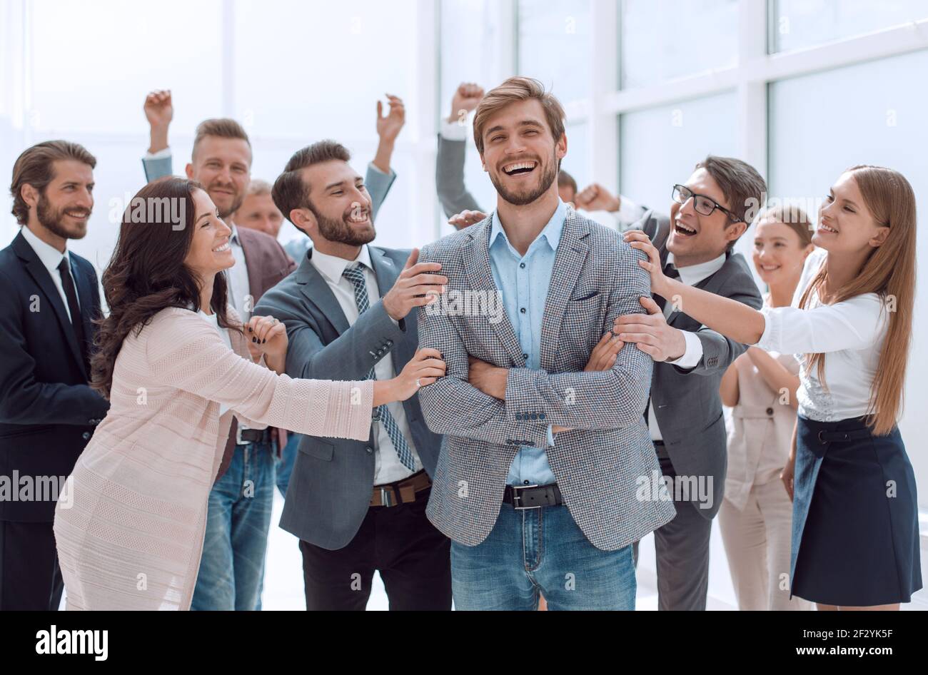smiling entrepreneur on the background of jubilant business team Stock ...