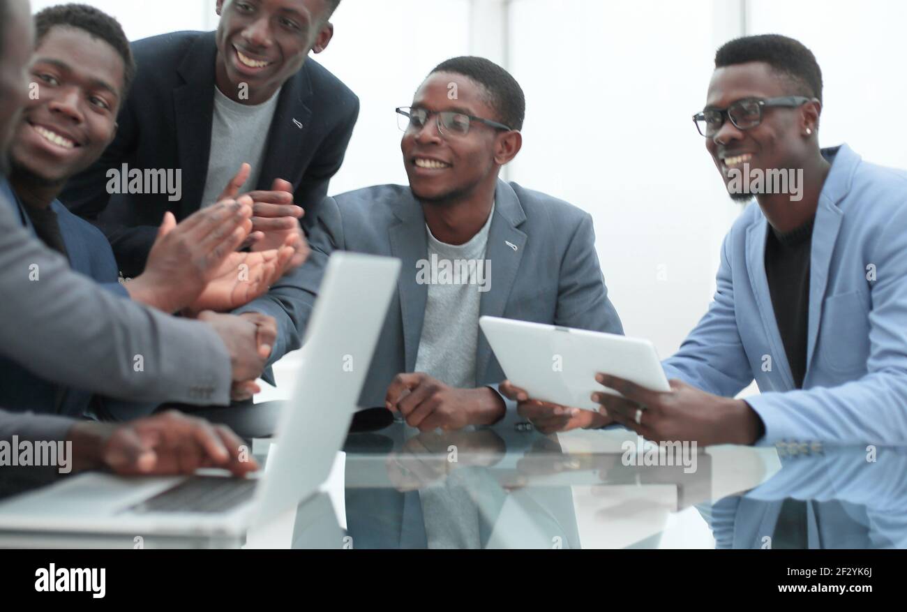 group of employees looking at the screen of a digital tablet Stock ...