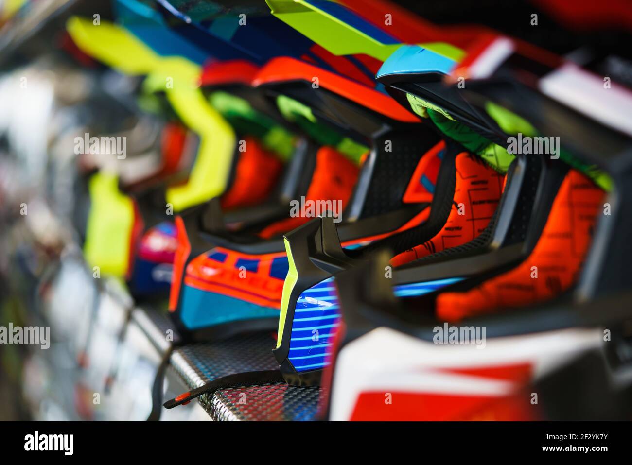 A row of motorcycle helmets on the shelf in the store Stock Photo - Alamy