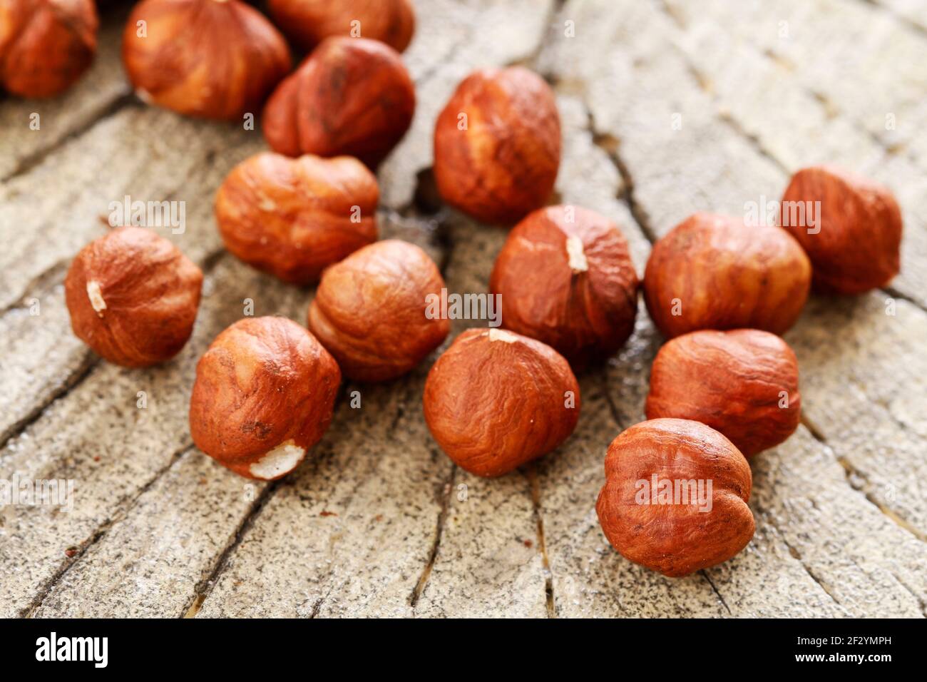 Hazelnuts on rough wooden background. Healthy food Stock Photo - Alamy