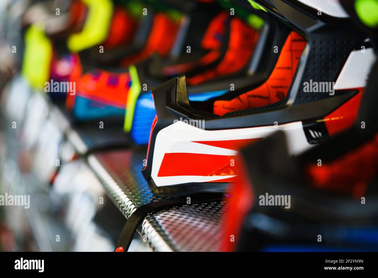A row of motorcycle helmets on the shelf in the store Stock Photo - Alamy