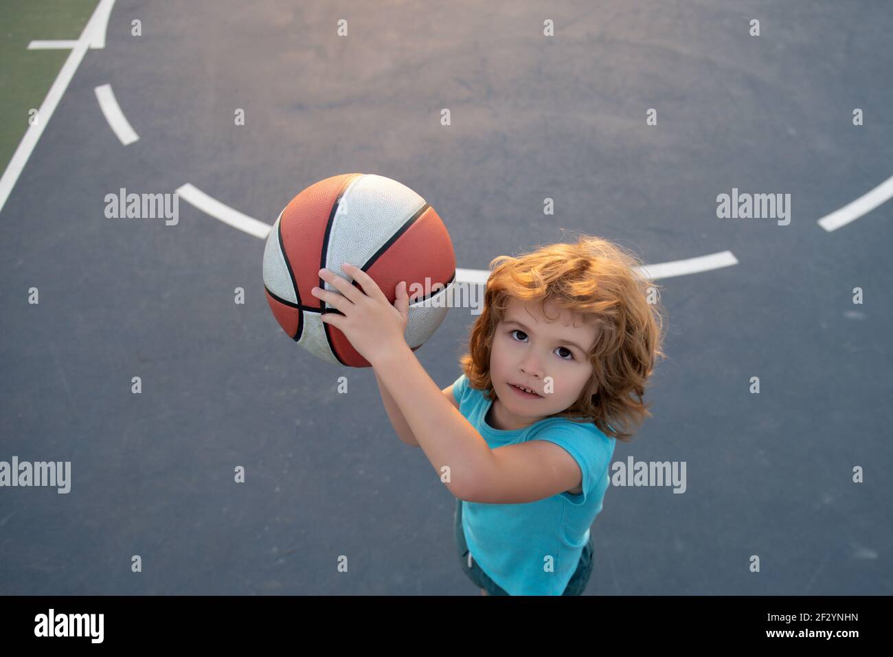 Kid boy concentrated on playing basketball, Top view. Basket ball kids ...