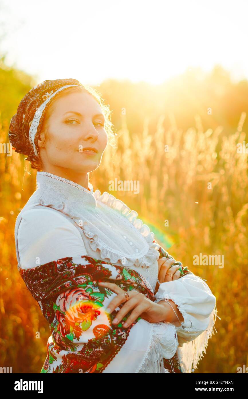 Young beautiful slovak woman in traditional costume on summer daisy ...