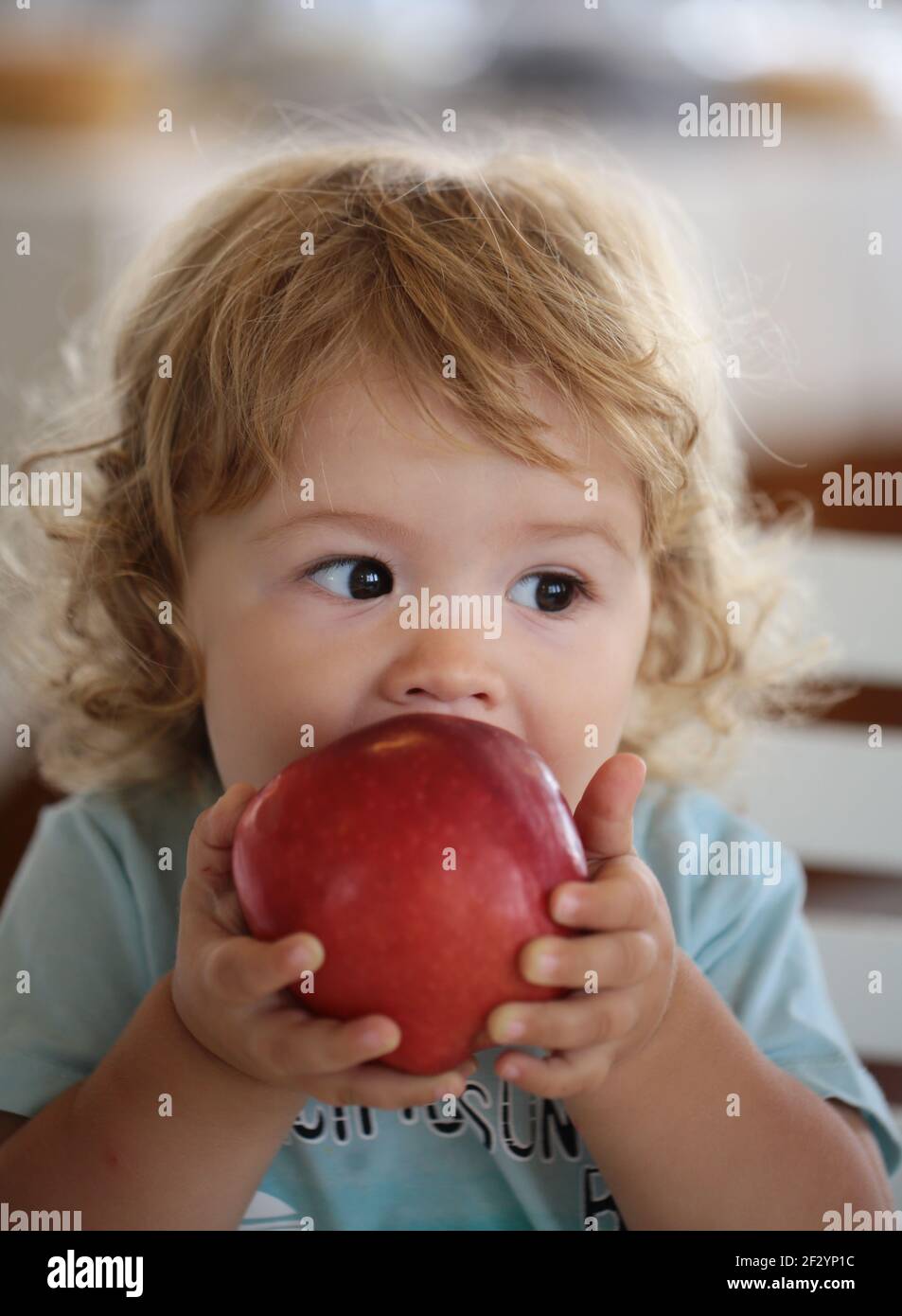 Funny baby eat apple. Kid eating fruit. Little boy biting apple ...