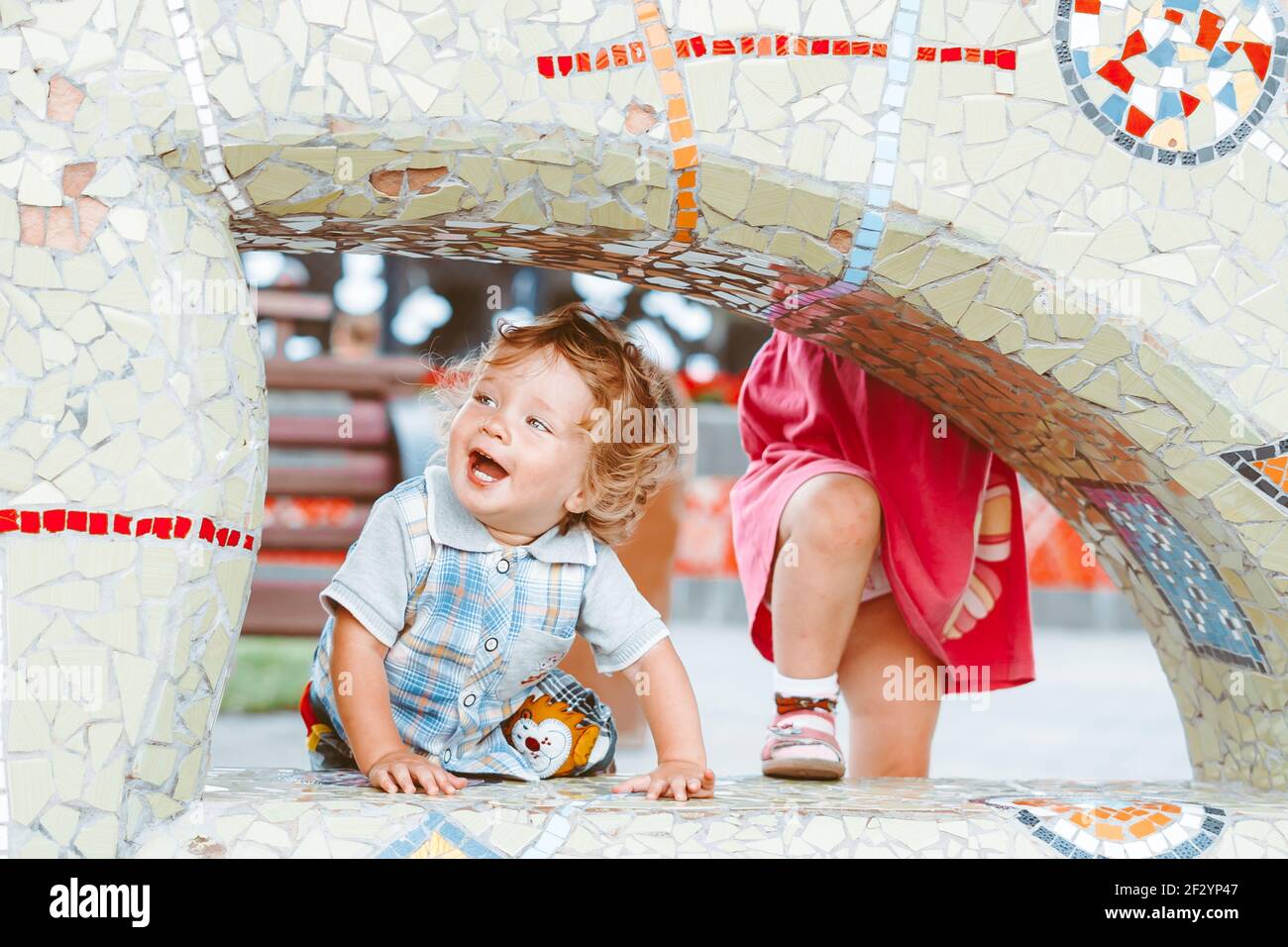 Two funny kids are playing, covering his face with his hands Stock ...