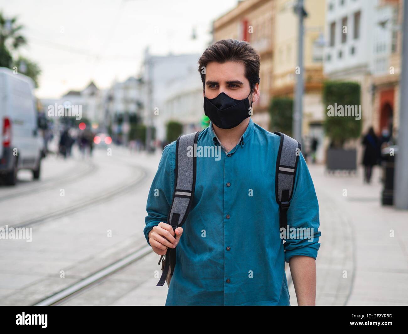 A Spanish male with face mask walking outdoors - concept of the new ...