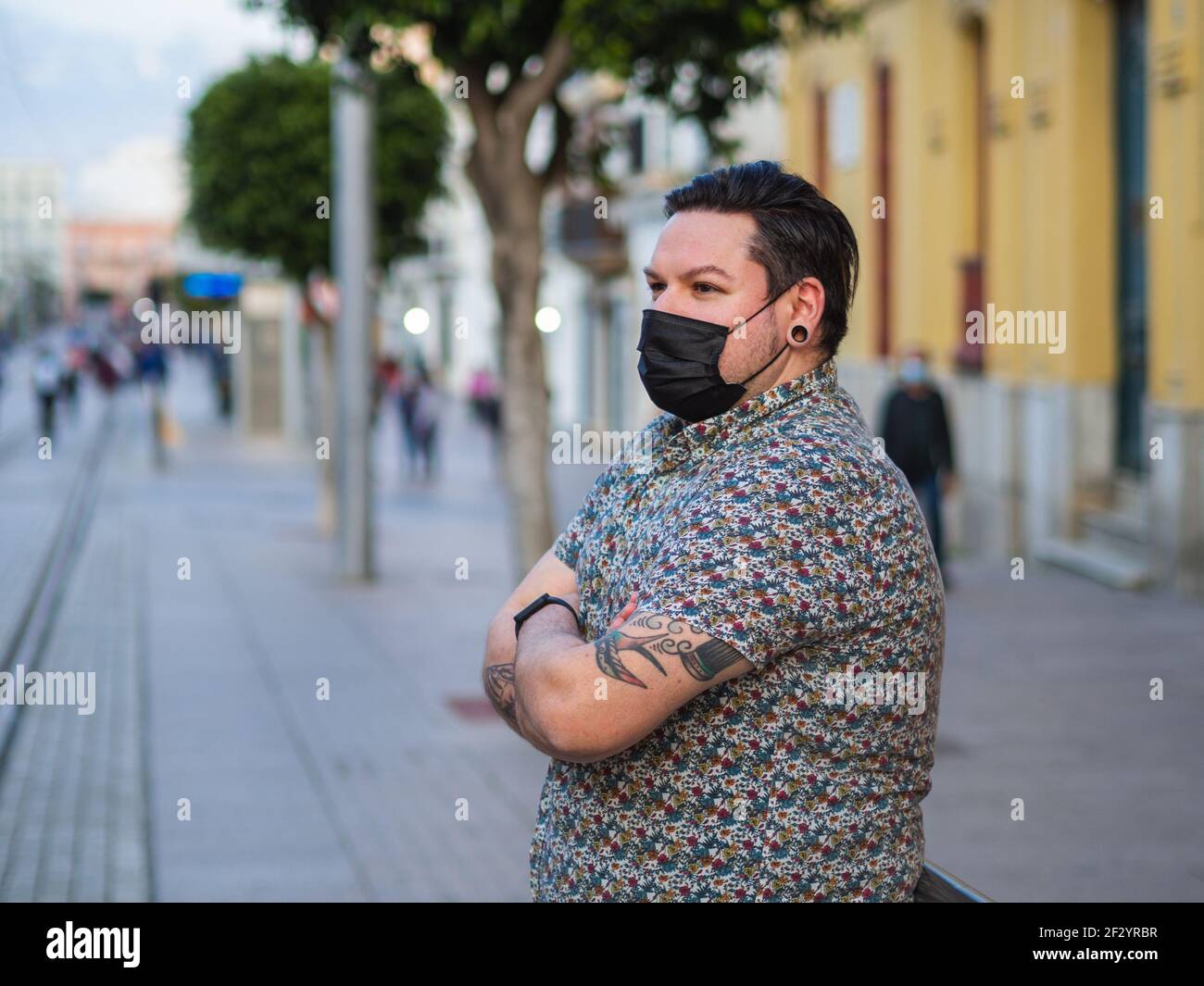 A Spanish male with folded arms outdoors - concept of the new normal ...