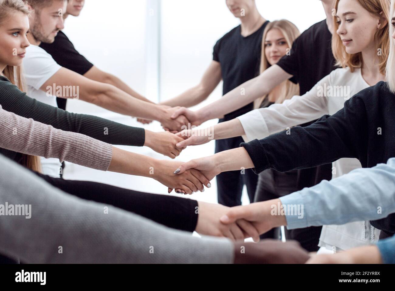 diverse young people shaking hands with each other Stock Photo - Alamy