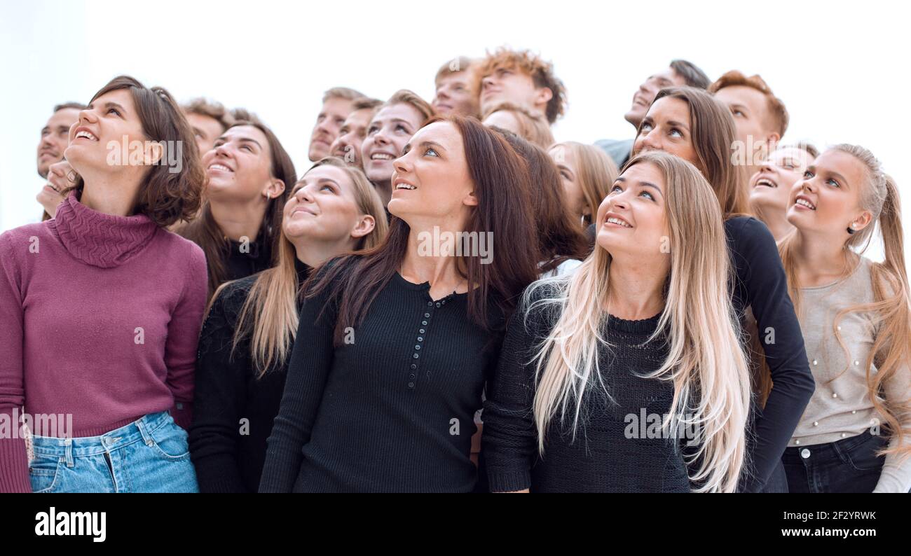 close up. happy young people looking up somewhere Stock Photo - Alamy