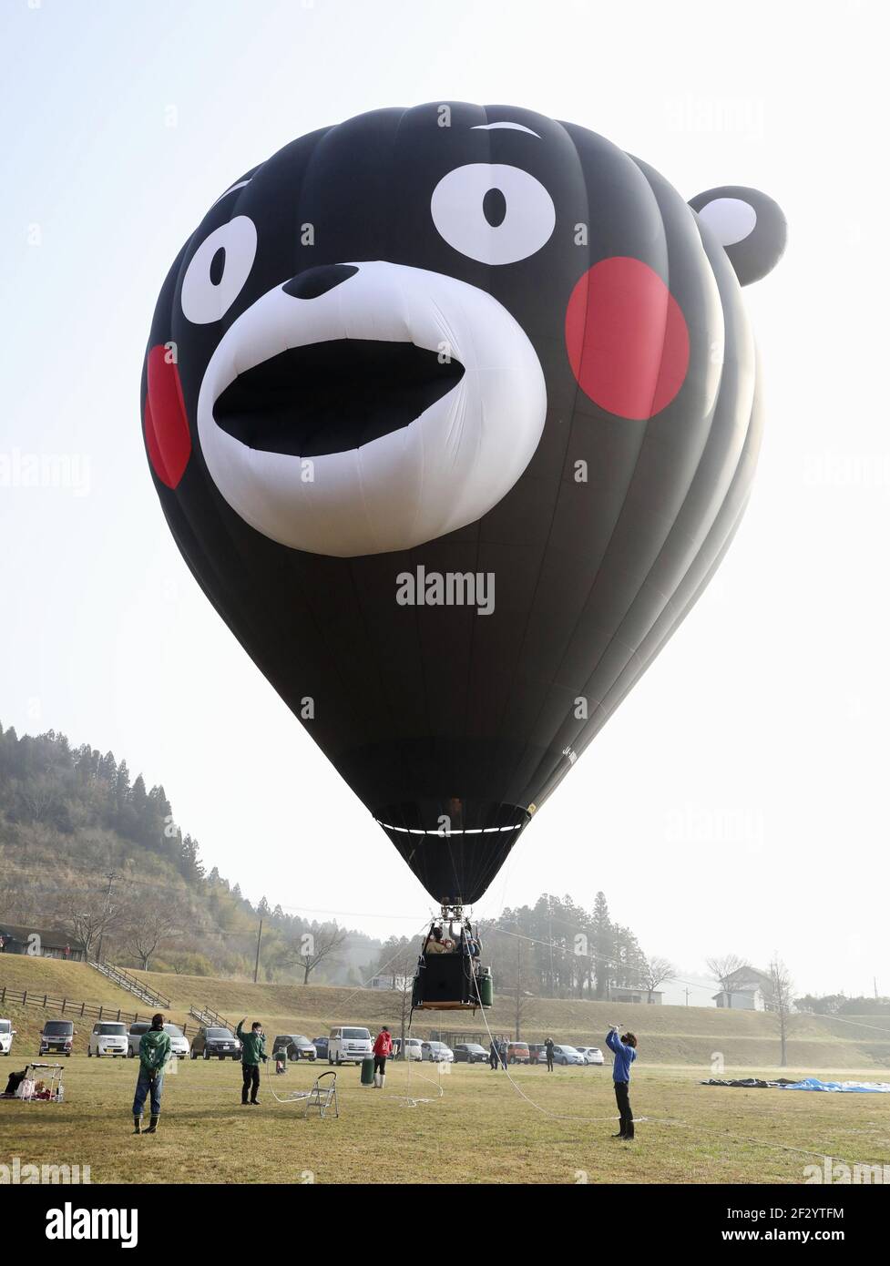 A hot-air balloon bearing the face of Kumamon, the popular black bear ...