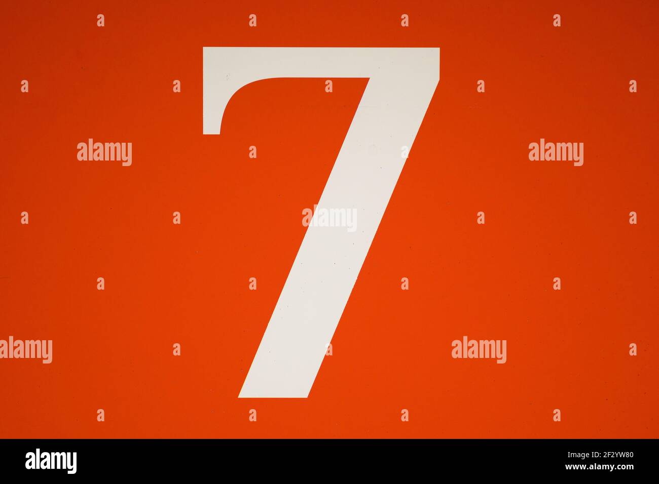 Colorful red and white sign with the number seven - 7 - stencilled in ...