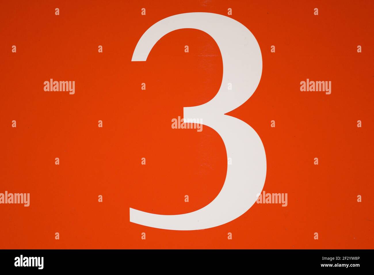 Colorful red and white sign with the number three - 3 - stencilled in ...