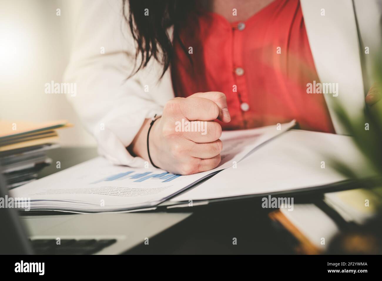 Angry businesswoman hitting her desk with her clenched fist Stock Photo ...