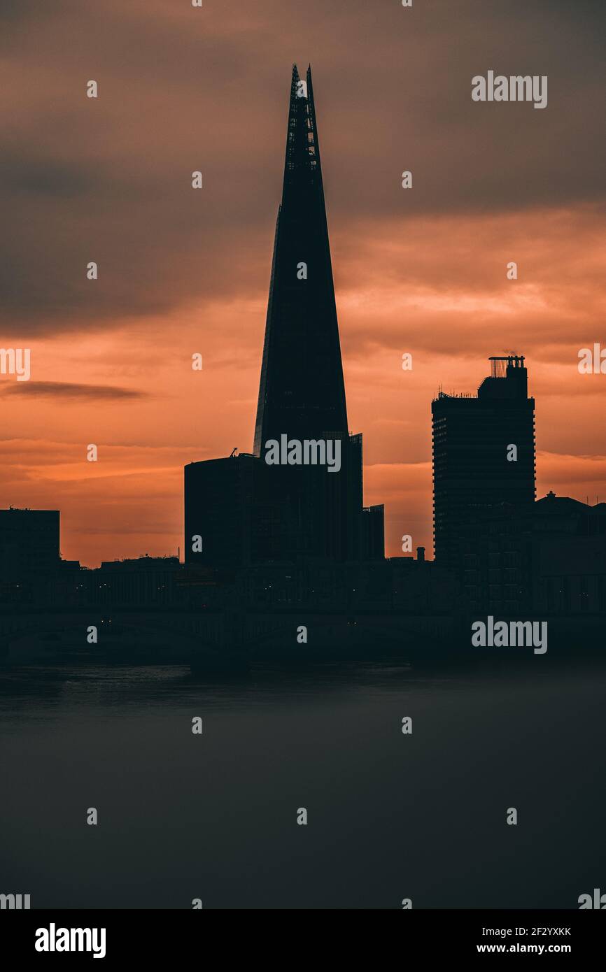 Dark late sunset over the city of London, orange sky showing ...