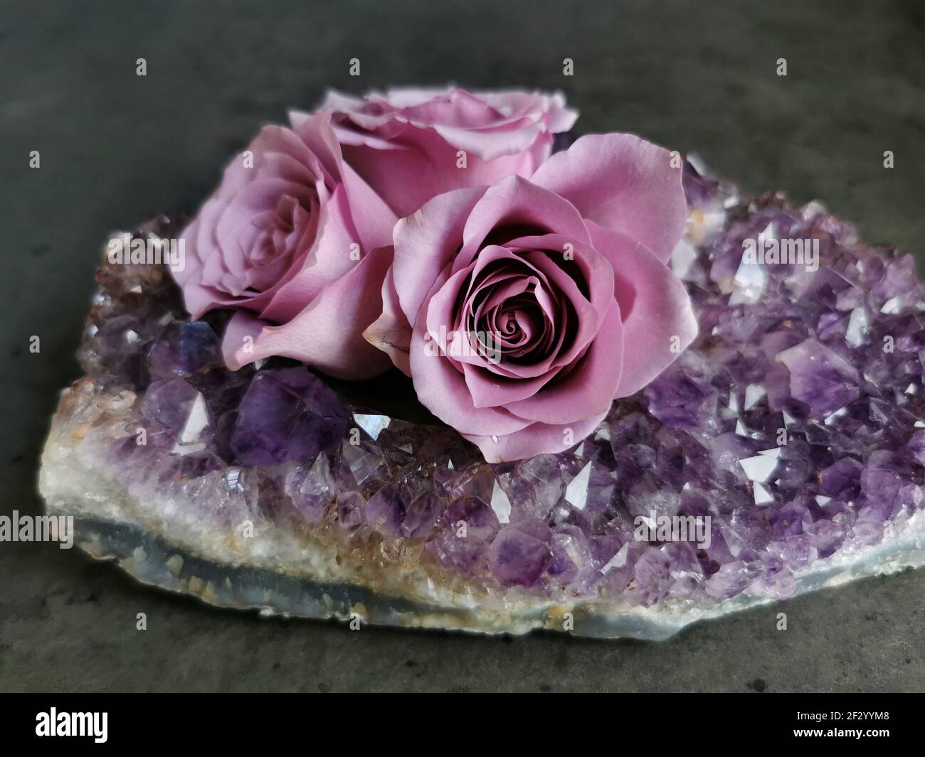 A decoration with pink roses and amethyst druse Stock Photo - Alamy