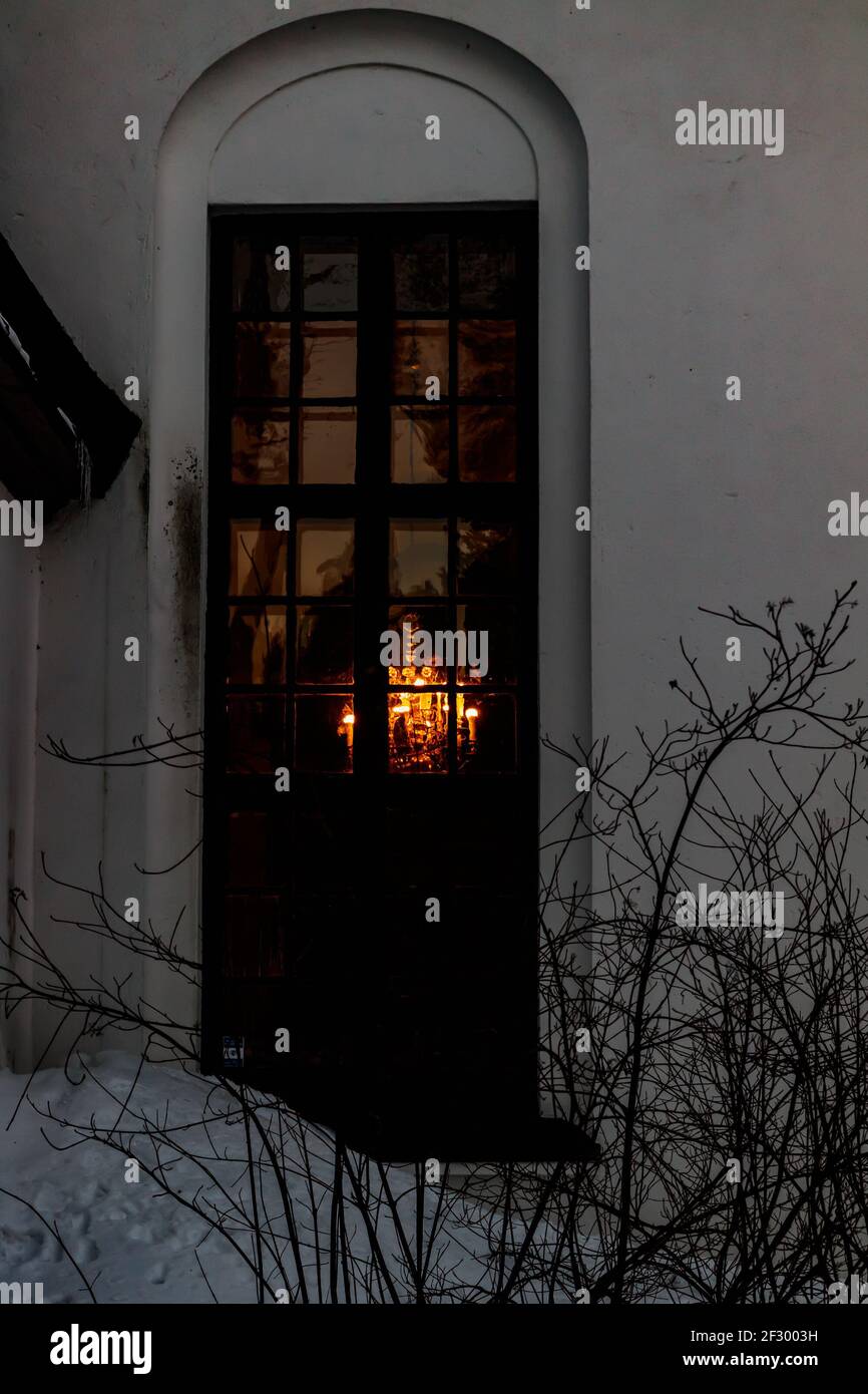 Beautiful chandelier light through the window of church of Valkeala in ...