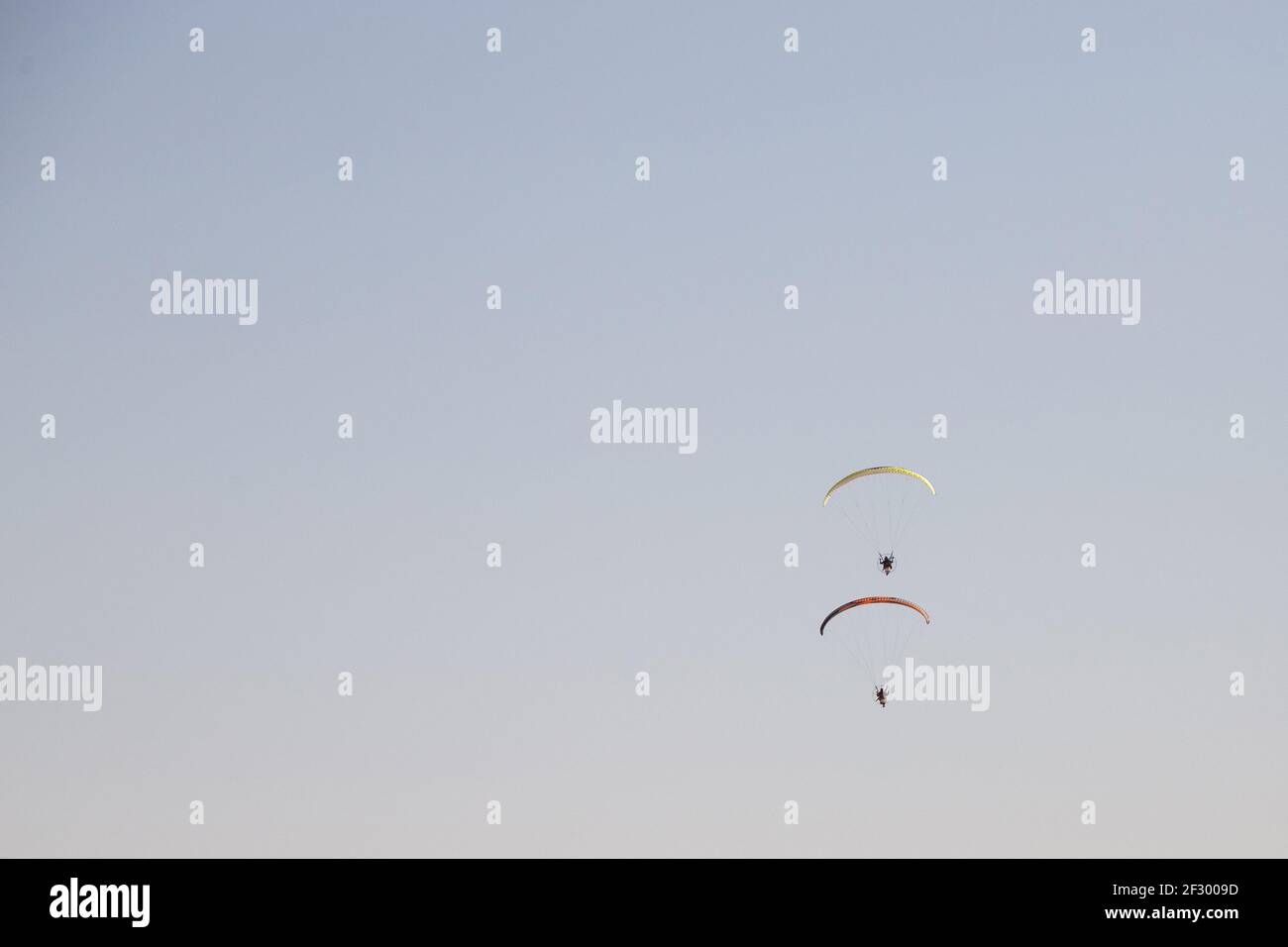 A clear sky with two para planes flying Stock Photo - Alamy