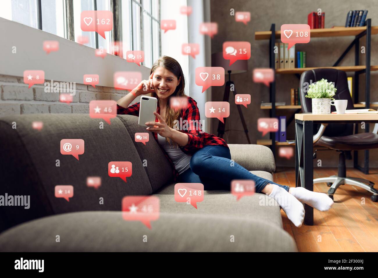 Happy woman chats via smartphone with social network messages, chat and ...