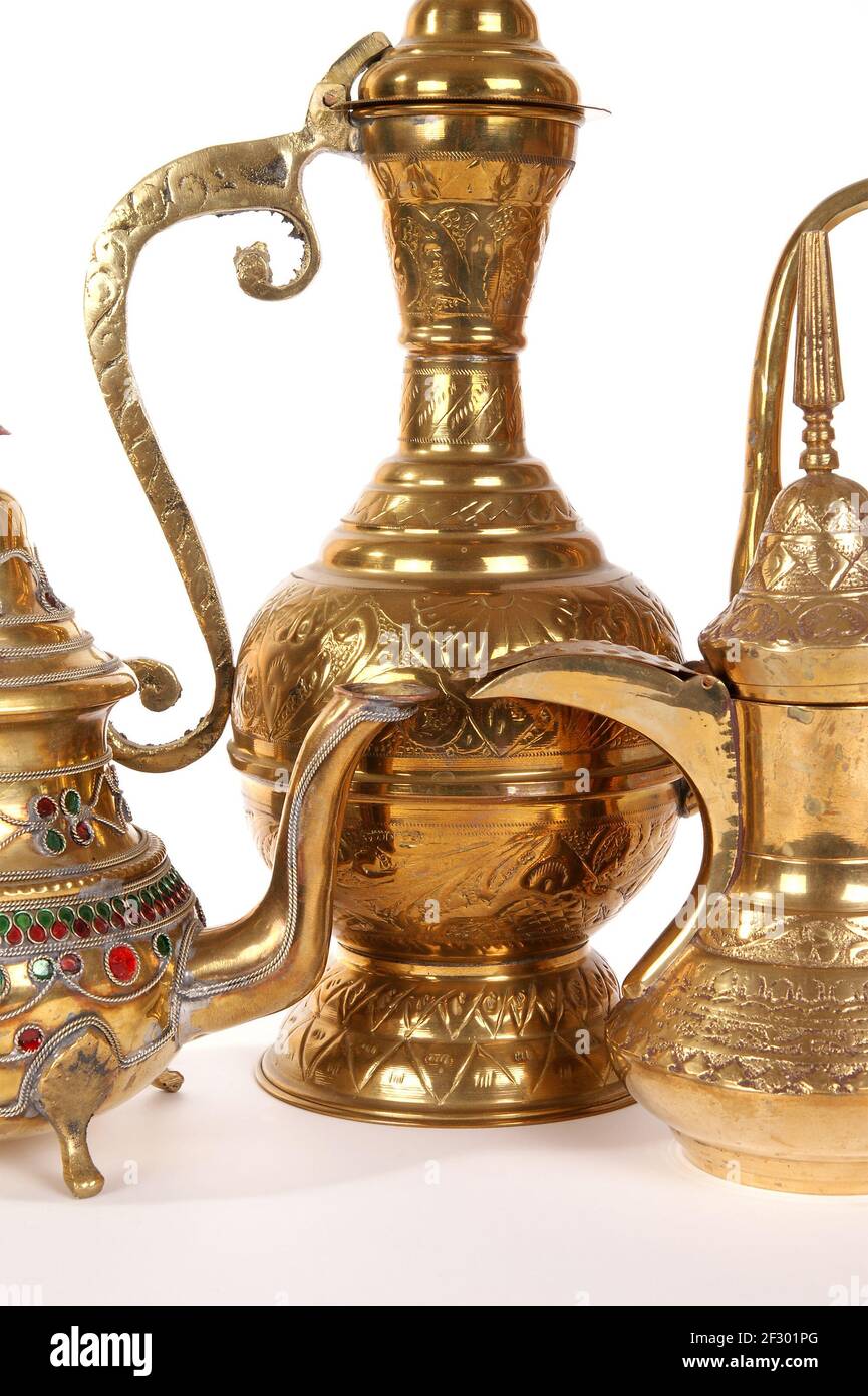 Copper jug with a traditional Arabic ornaments on a white background ...