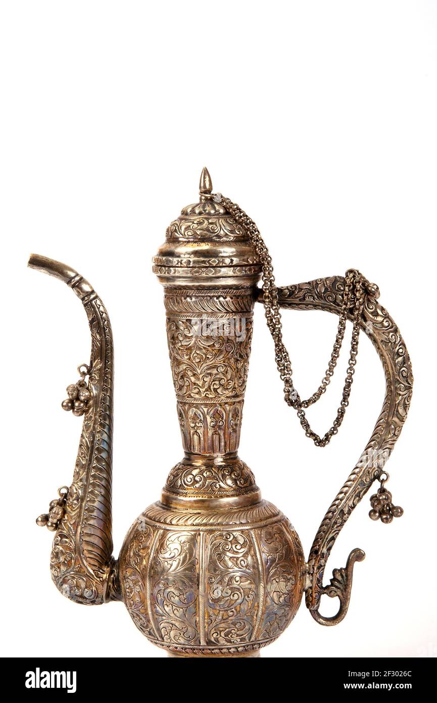 Copper jug with a traditional Arabic ornaments on a white background ...