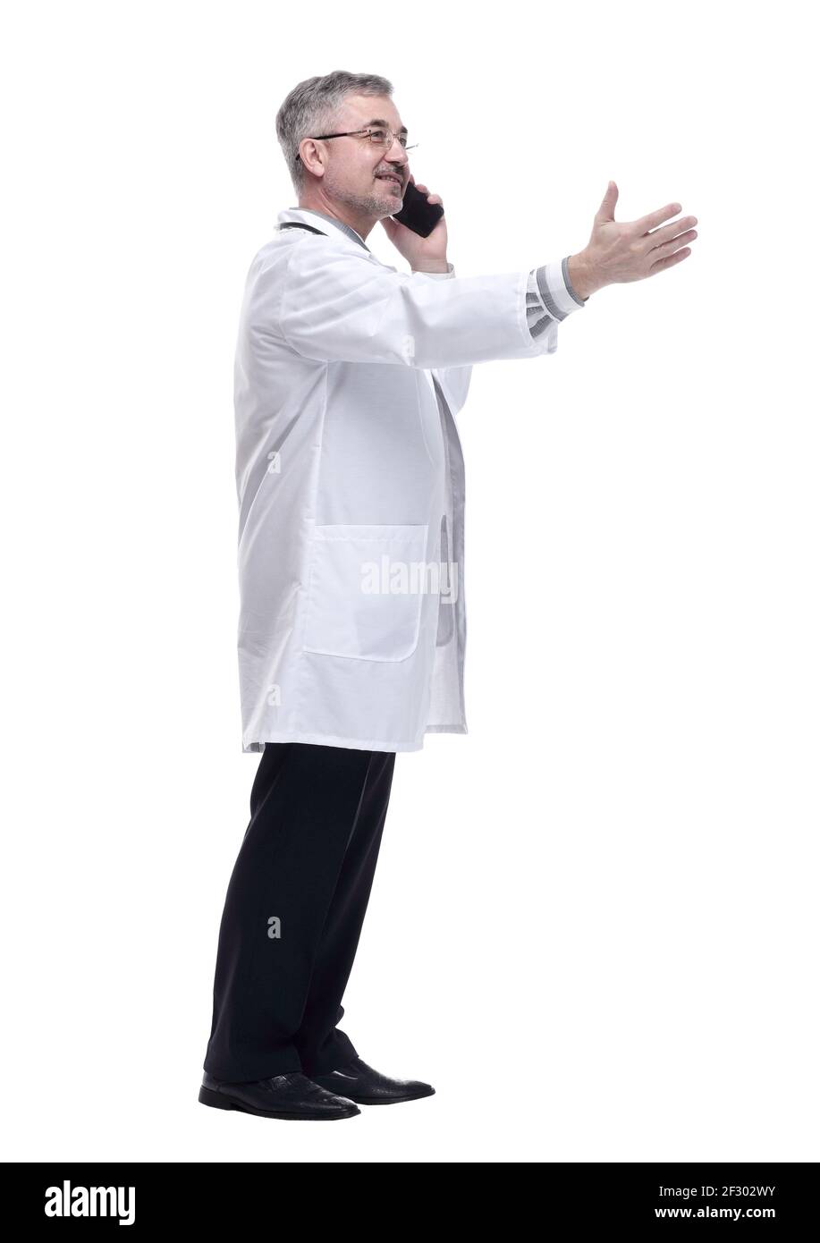smiling medic with a smartphone pointing at a white screen Stock Photo ...