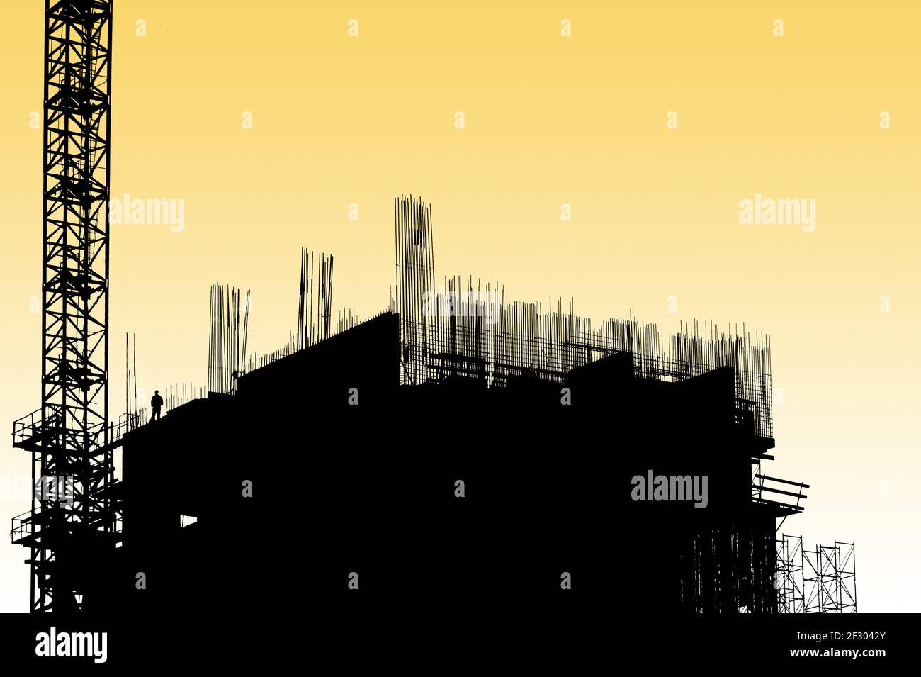 construction equipment and elements of a building under construction ...