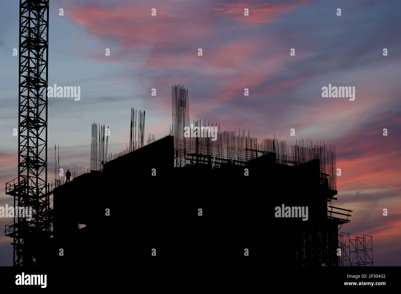 construction equipment and elements of a building under construction ...