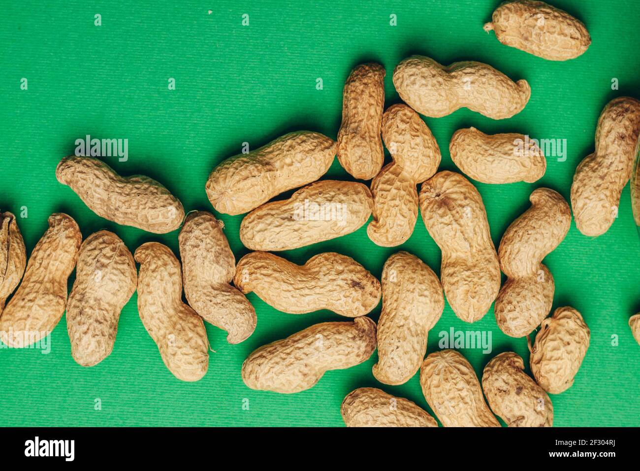 peanuts in shells snack Green background snack for alcohol Stock Photo ...