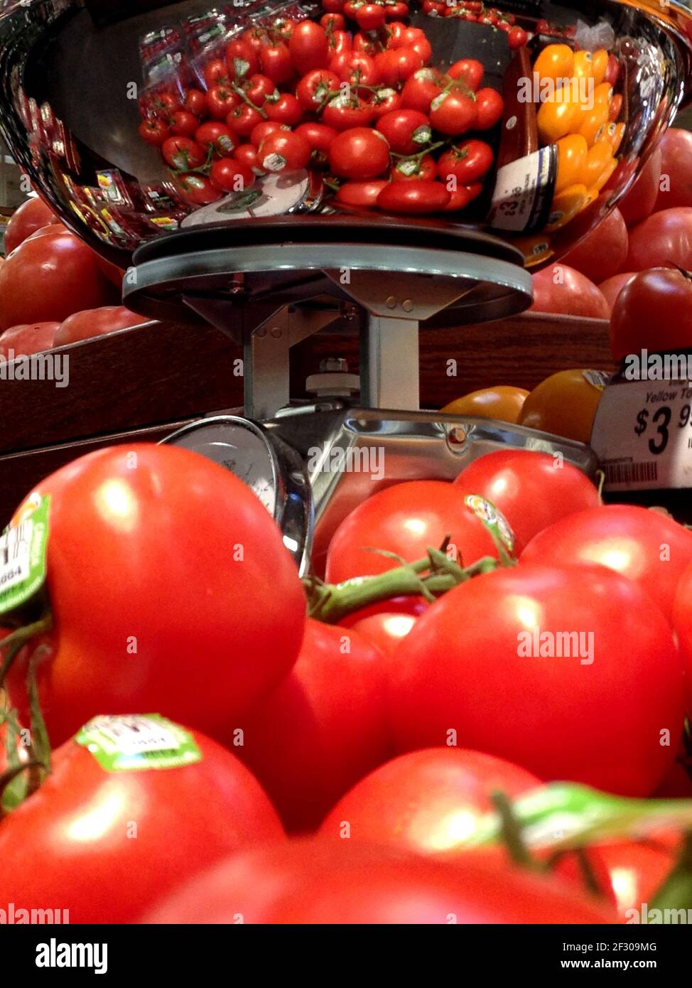 Tomatoes for sale in the produce isle of a grocery store in the USA ...