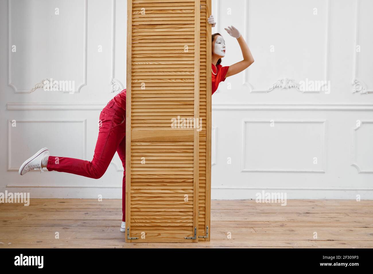 Two mime artists, scene with wooden partition Stock Photo - Alamy