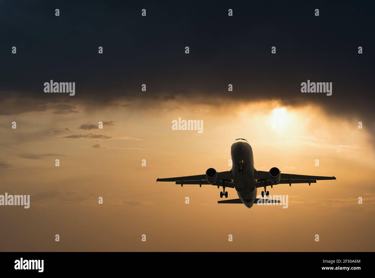 Plane goes on takeoff at sunset Stock Photo - Alamy