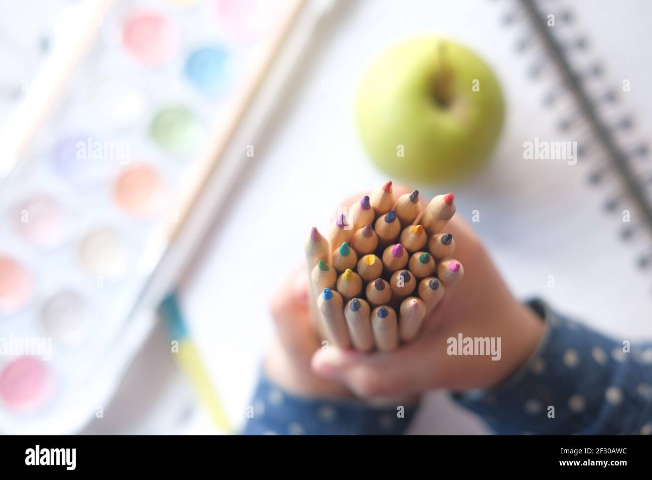 top view of child holding colored pencil on a table Stock Photo - Alamy