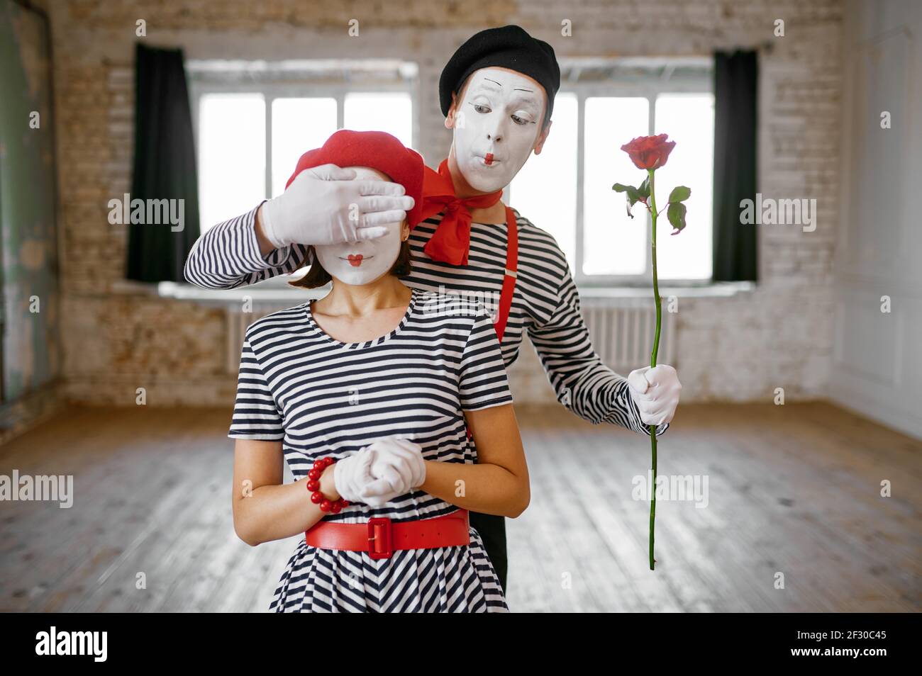 Mime artists, surprise with rose scene Stock Photo - Alamy