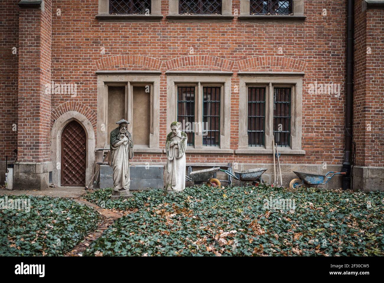 Abandoned old stone religious statues outside empty building being ...