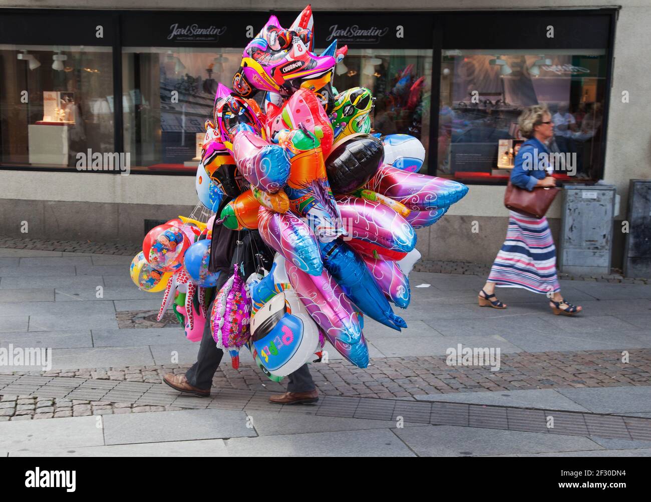Someone who is on his way to his job as a seller of balloons during ...