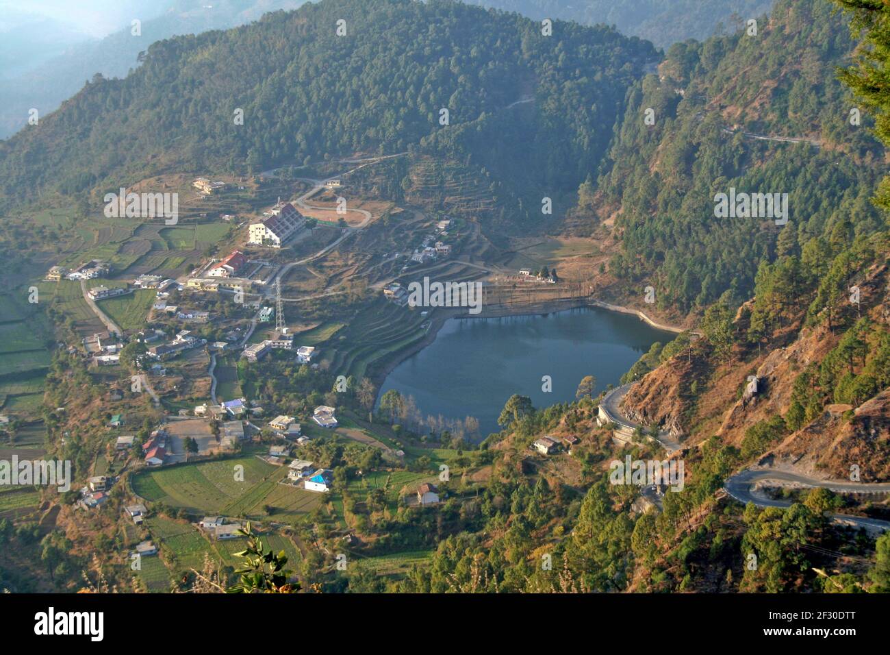 A top view of a lake surrounded by mountains near Nainital, Uttarakhand ...