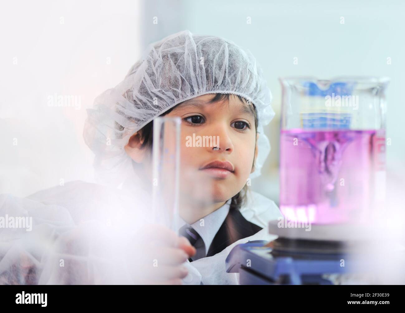 Smart cute little male child experimenting with test tubes in real ...
