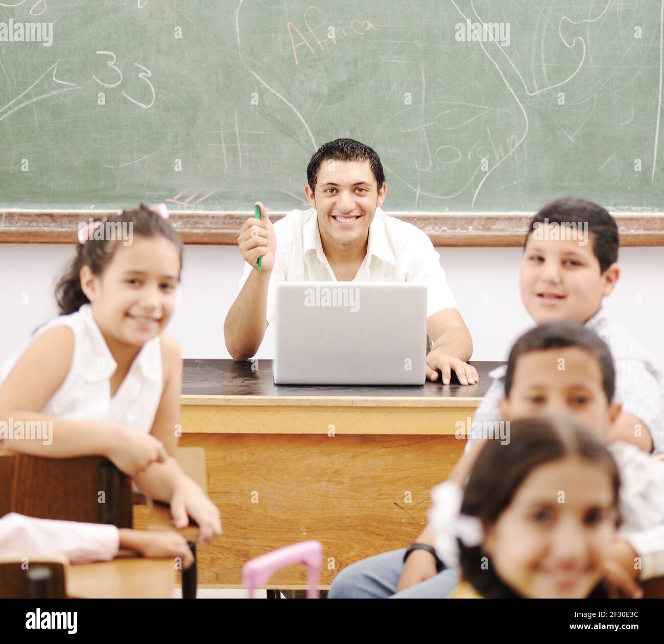 Elementary school kids in classroom Stock Photo - Alamy