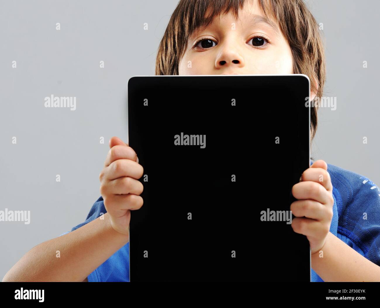 Cute little boy with Tablet PC Stock Photo - Alamy