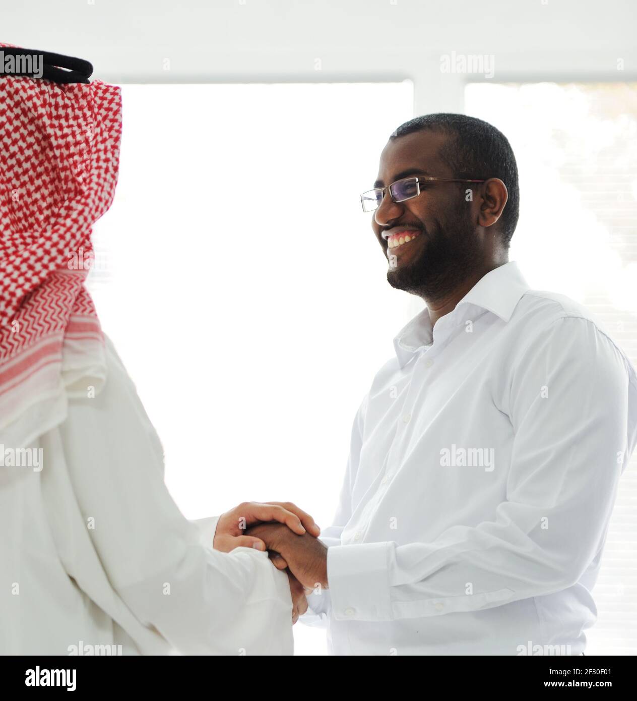 Arabic and African American business men Stock Photo - Alamy