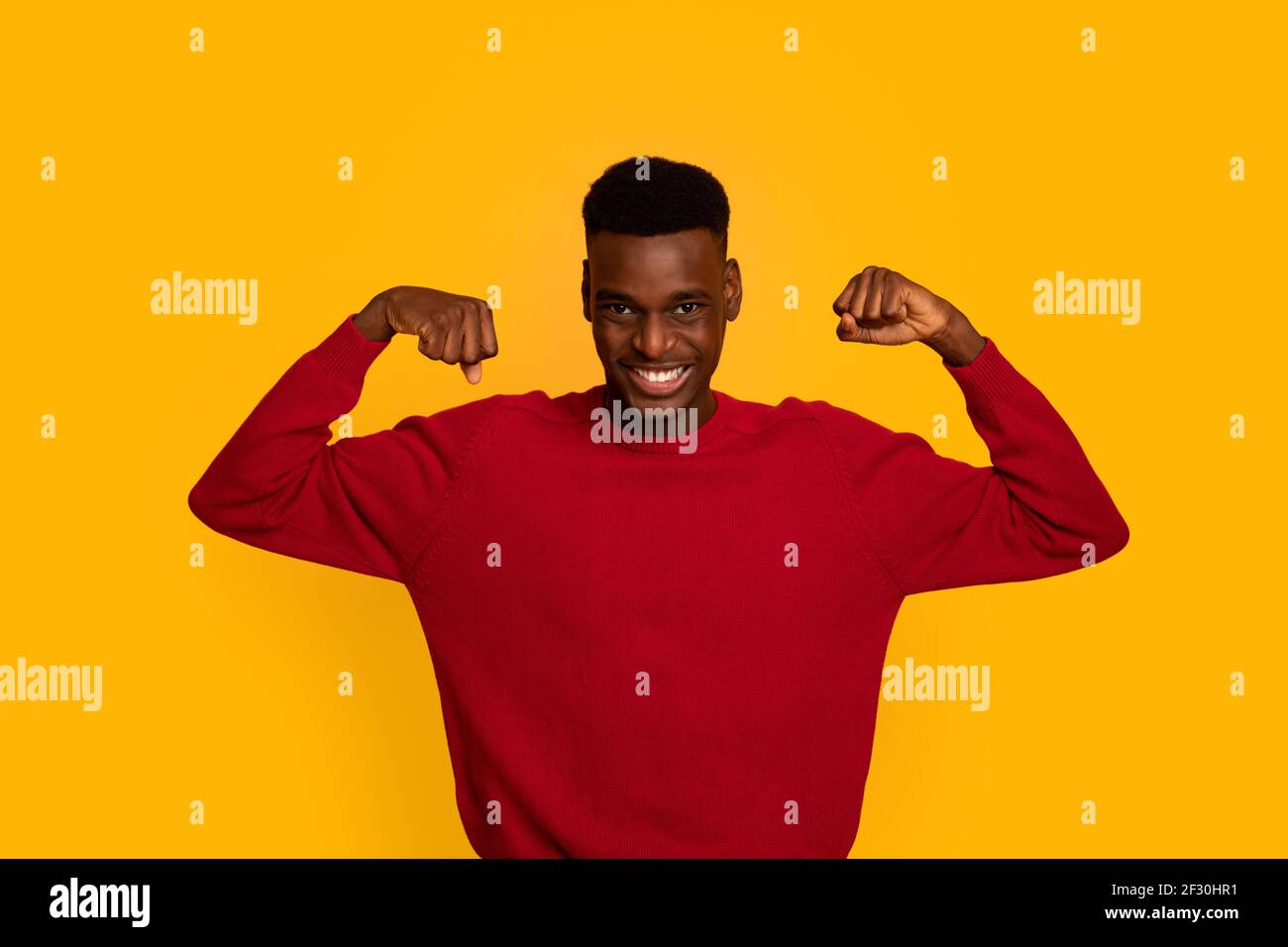 Young black man showing muscles hi-res stock photography and images - Alamy